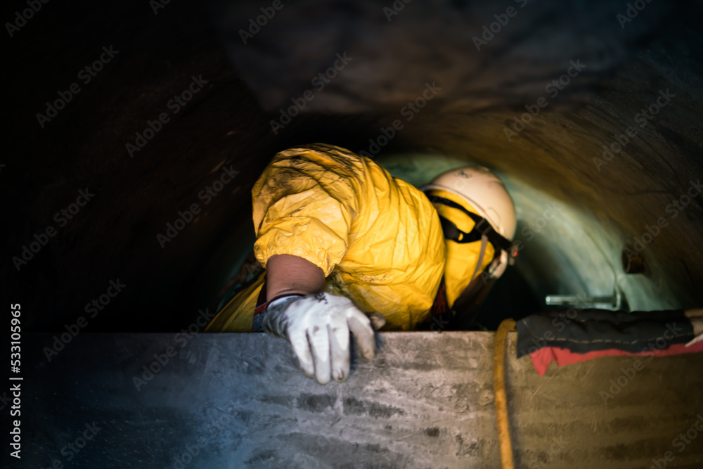 Employees inspect by taking photographs of internal pressure tanks in ...