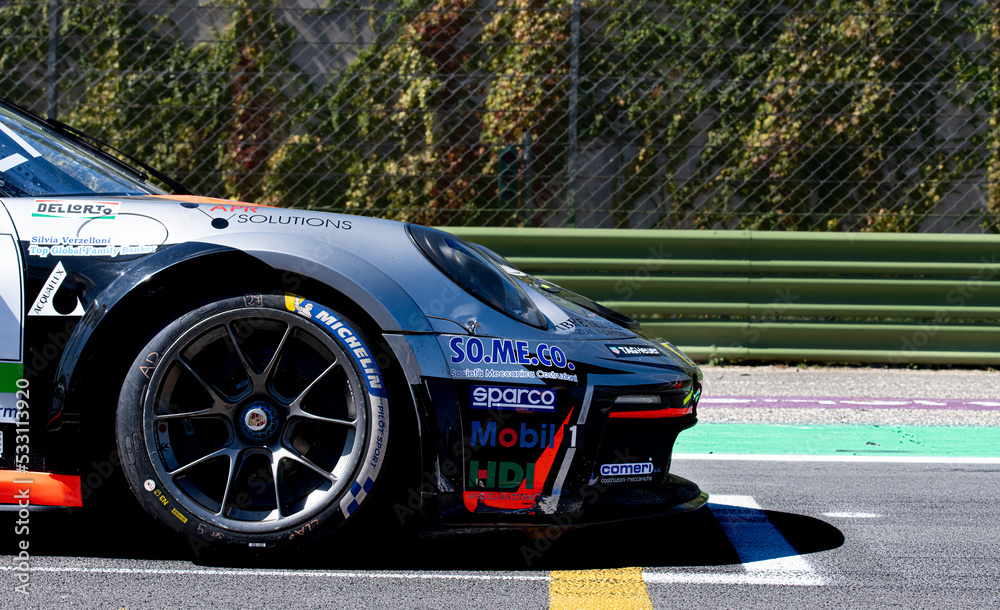 Porsche Carrera race car standing in racetrack starting grid detail ...