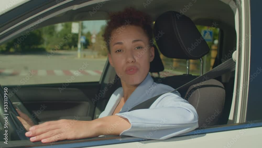 Positive attractive African American female driver in formalwear ...
