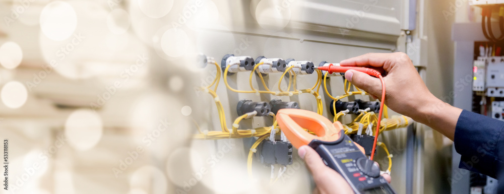 Electrical engineer using measuring equipment to checking electric ...