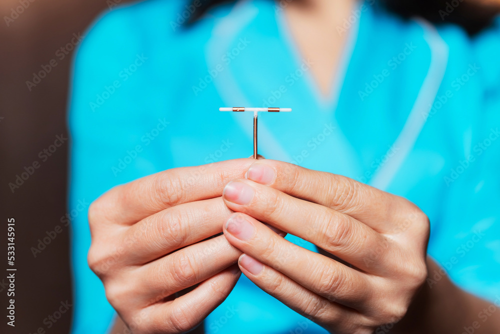 female contraceptive spiral in the hands of a nurse. device forbidding ...