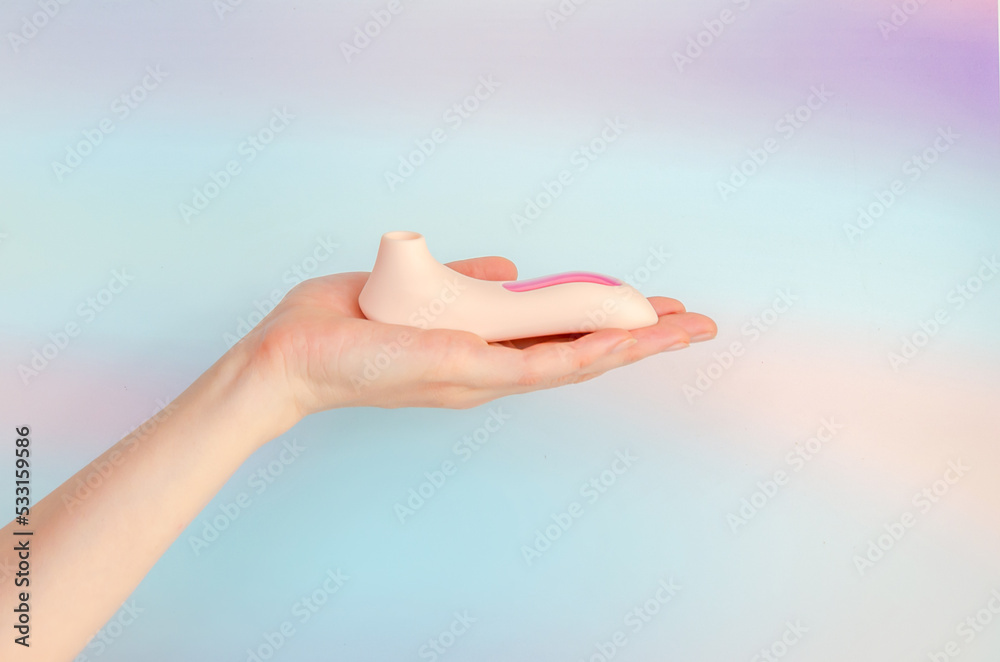 Pink Vacuum Wave Vibrator For Clitoral Stimulation In An Elegant Female