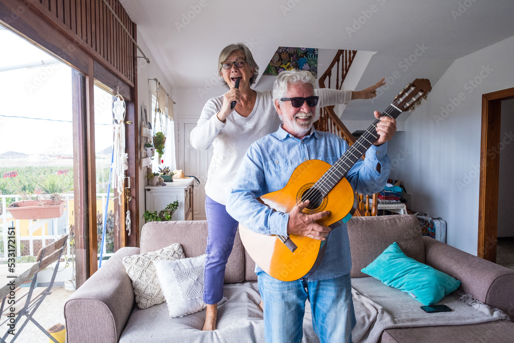 Happy and funny couple of old and mature people having fun and enjoying ...
