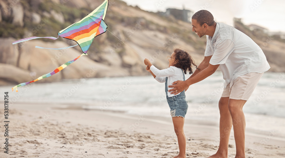 Father teaching child to fly a kite on beach wind with support, love ...