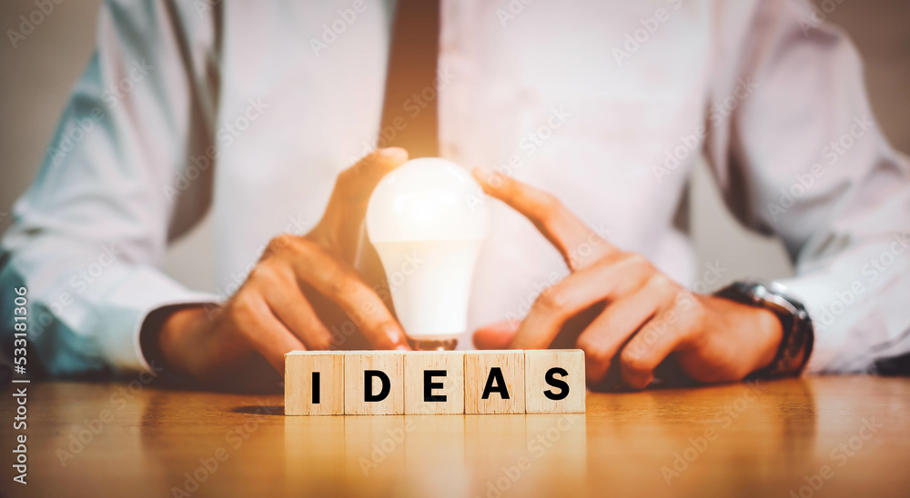 Concept creative idea and innovation. Wooden cube block with light bulb ...