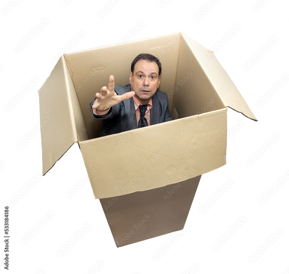 A man in a suit stands inside a cardboard box with his hand raised for ...