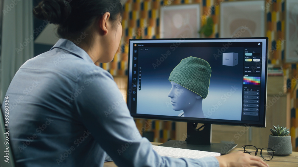 Female designer creating 3D visualization of clothes using computer and ...