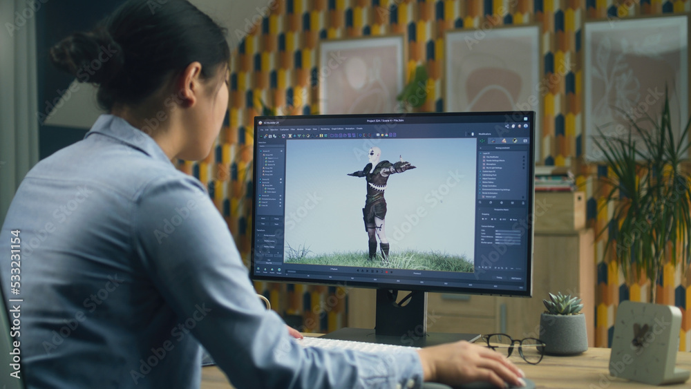 Asian female 3D designer making animation for video game character ...