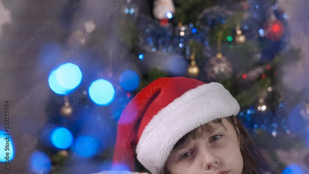 Dissatisfied child at Christmas. A little girl feel dissatisfied during ...