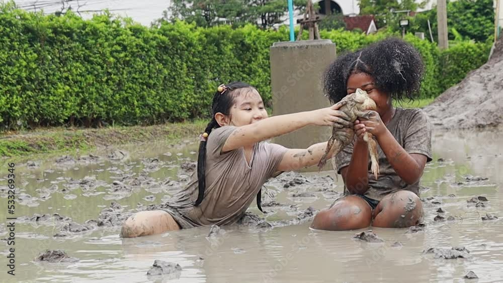 Two girls play in mud and catch frogs. outdoor learning outside the ...