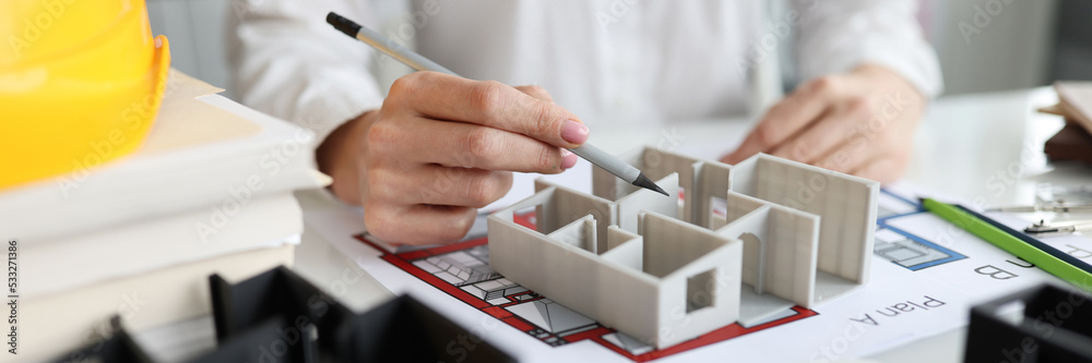 Woman designer showing 3d model of house in studio closeup Stock Photo ...