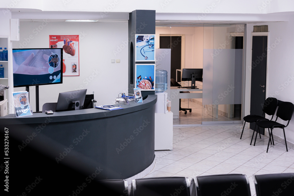 Empty hospital reception counter in hallway and waiting room seats ...