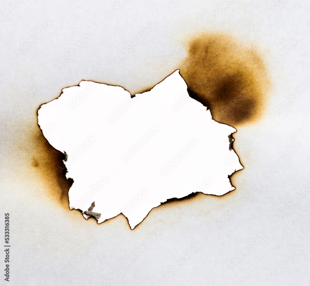 Burned hole on a white paper Stock Photo | Adobe Stock