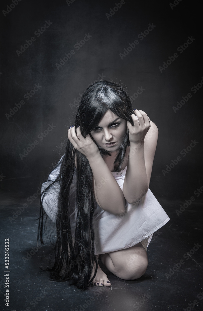 Mystical ghost woman sitting on black background Stock Photo | Adobe Stock