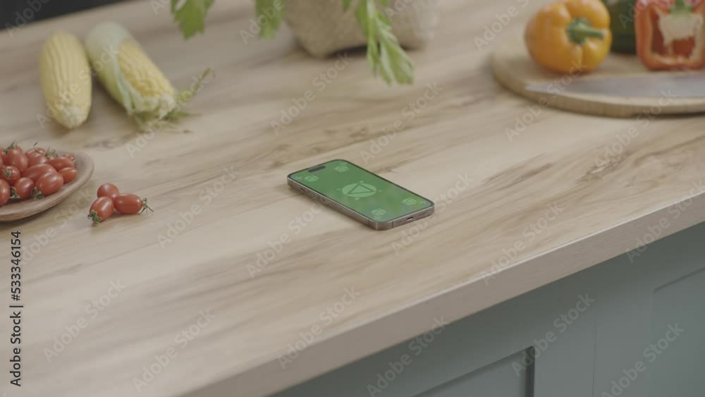 iPhone 14 pro on kitchen table green screen mock-up, fresh vegetable ...