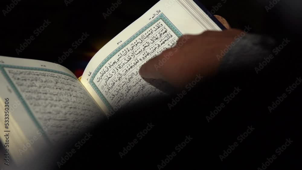 Reading Quran, Reading a Koran, Reading a Holy Quran with finger ...