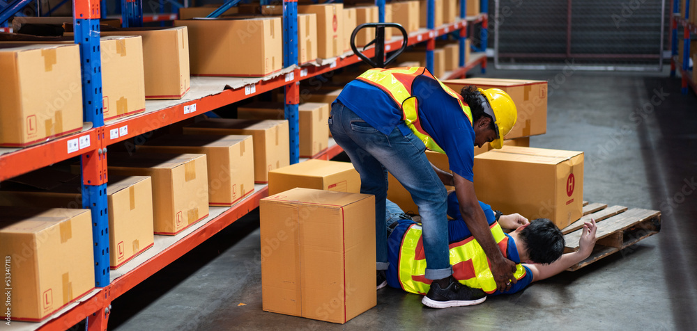 Warehouse factory worker helping to pick up colleague, Parcel box falls ...