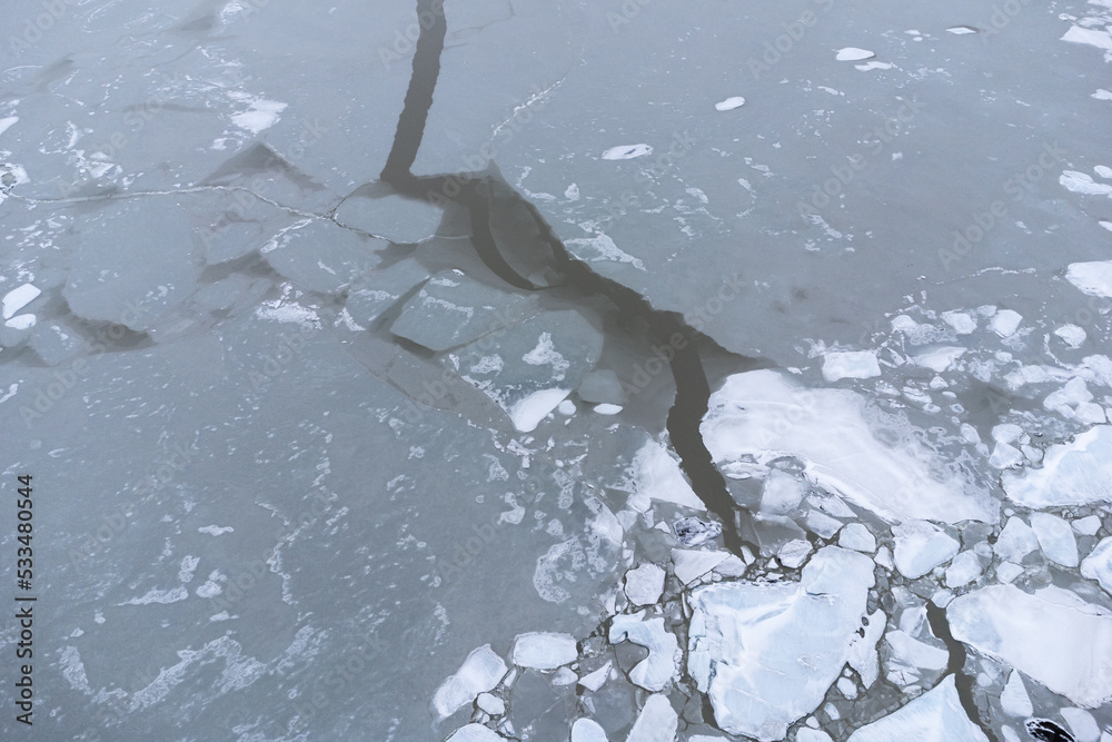 Cracked surface of frozen sea with glaciers Stock Photo | Adobe Stock