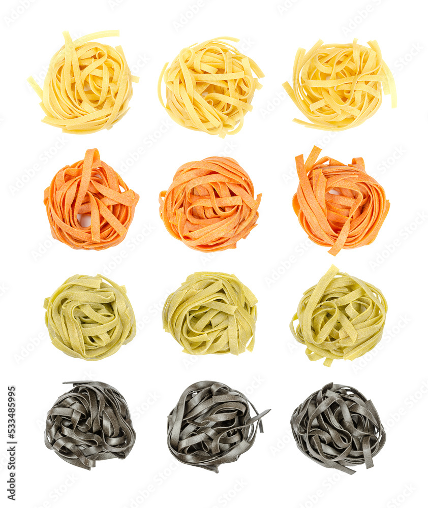 Colored tagliatelle pasta, twisted into nests, from above, isolated ...