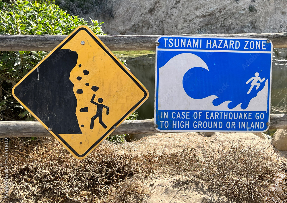 Tsunami Warning sign and Falling Rocks sign side by side Stock Photo ...
