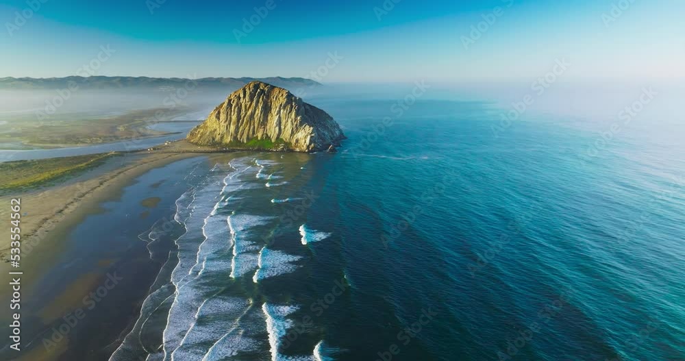 Splendid scenery of Pacific Ocean coastline with huge rock on the beach ...