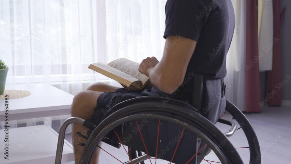 Young physically handicapped person reading a book at home. Disabled ...
