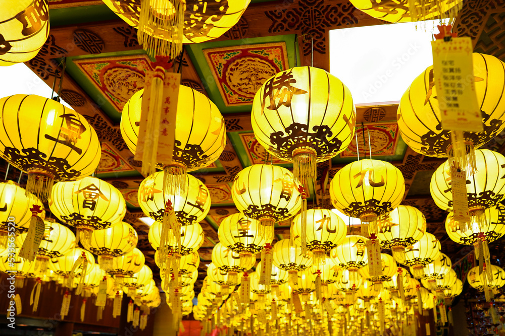 Light up lamp hanging on temple ceiling interior decoration in Thai ...