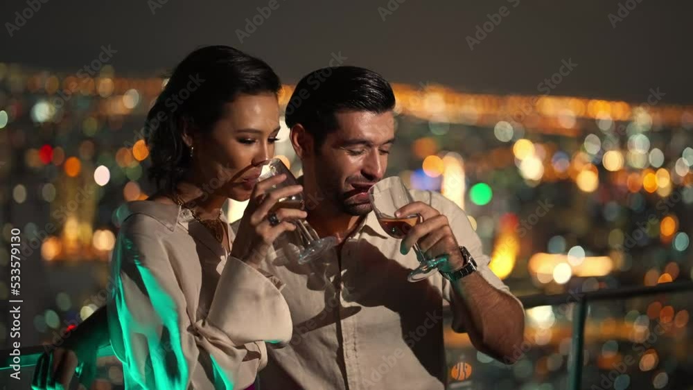 4K Caucasian couple celebrating holiday event at luxury skyscraper ...