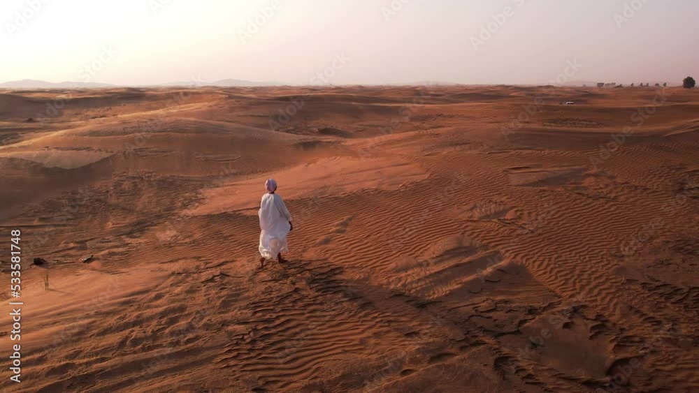 Arab man walking barefoot through the desert Stock Video | Adobe Stock