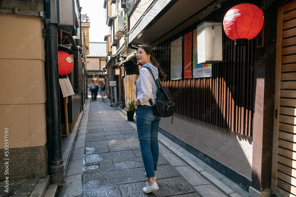 rear view with full length of asian Japanese woman traveler looking at ...