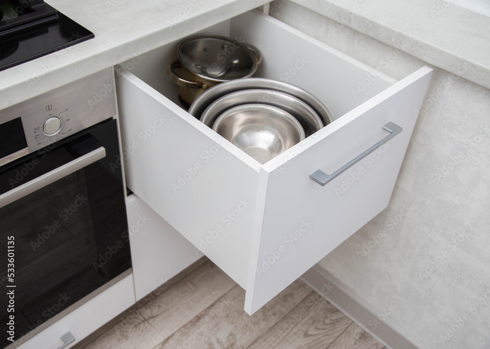 Modern sliding drawer system in the kitchen. Production of kitchen ...