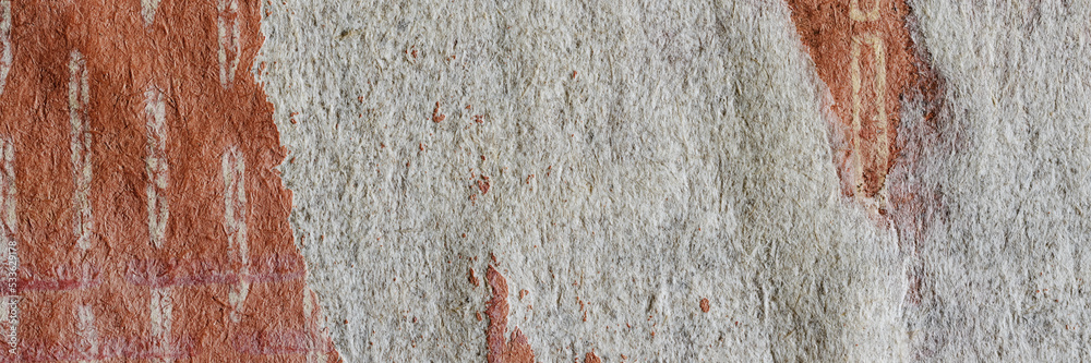 Torn old faded paper wallpaper with a retro pattern. Tattered scraps of ...