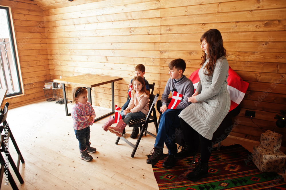 Family with Denmark flags inside wooden house. Travel to Scandinavian ...