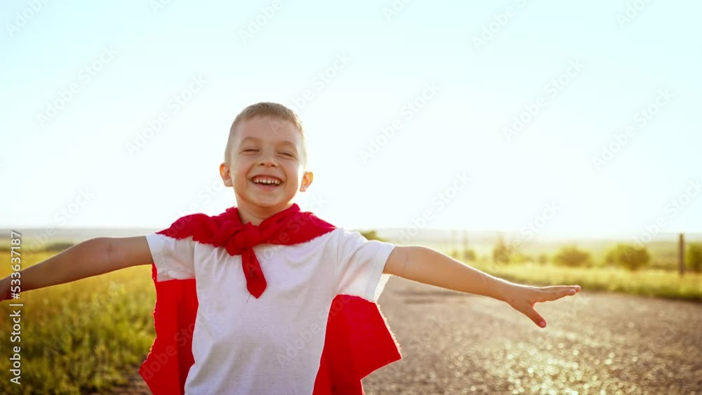 Close-up happy face of boy child running in superhero costume with red ...