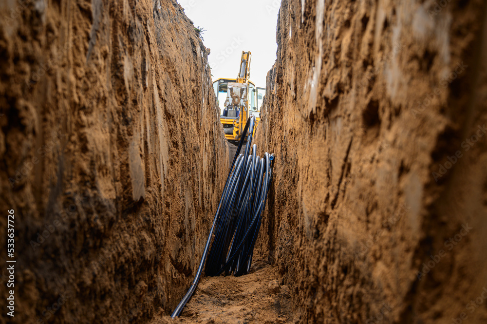 Installation of HDPE pipes in the trench. The process of laying of ...