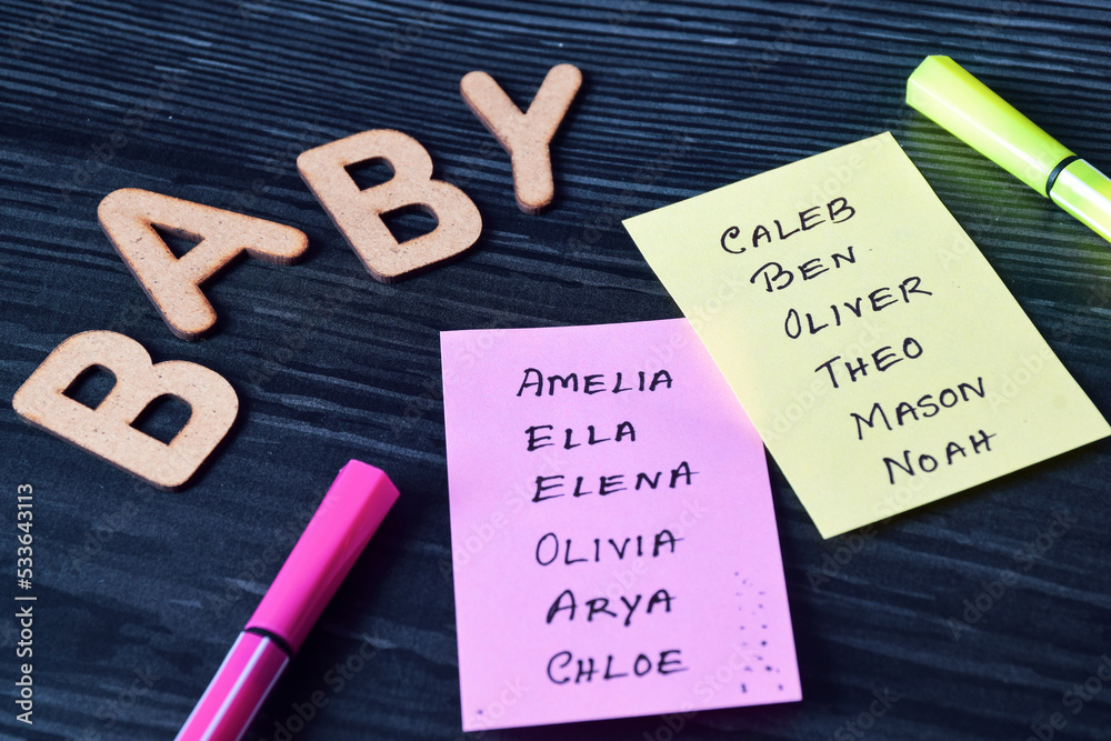 Newborn baby name suggestion list on desk with wooden alphabet letters ...