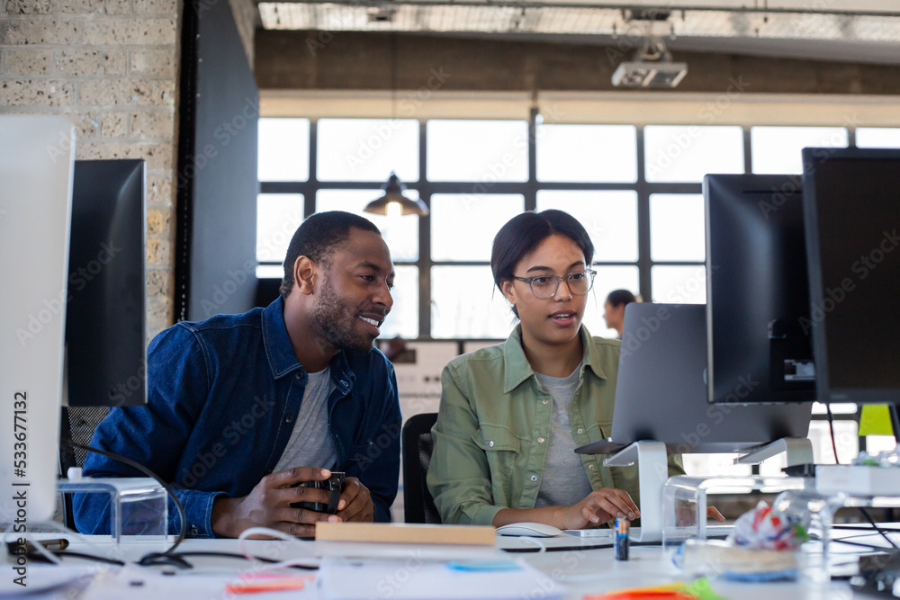 Coworkers working together at a desktop computer Stock Photo | Adobe Stock