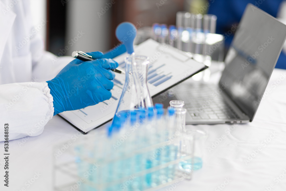 Scientists work with in vitro reagents in laboratories and draw ...