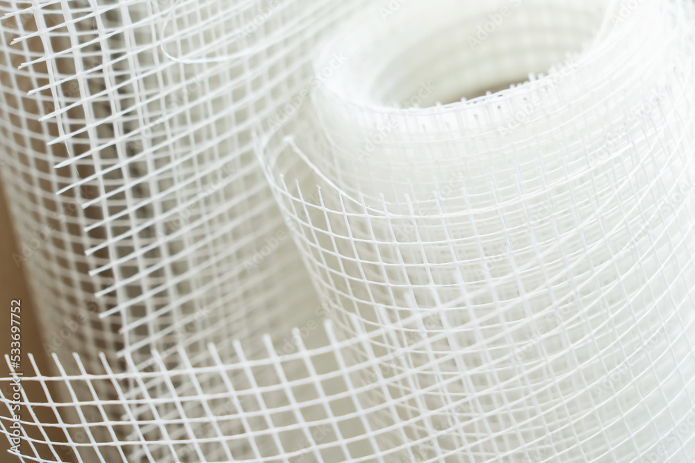 Polymer mesh for reinforcing walls and ceilings. Building material in a ...