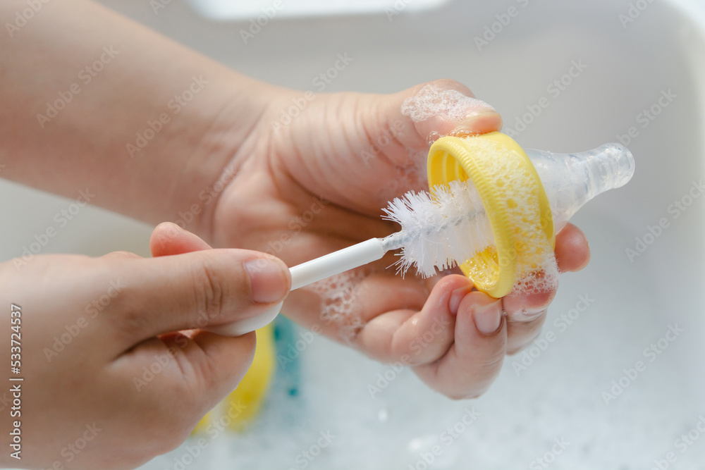 Washing baby nipples. Mother's hand washing the baby nipples Stock ...