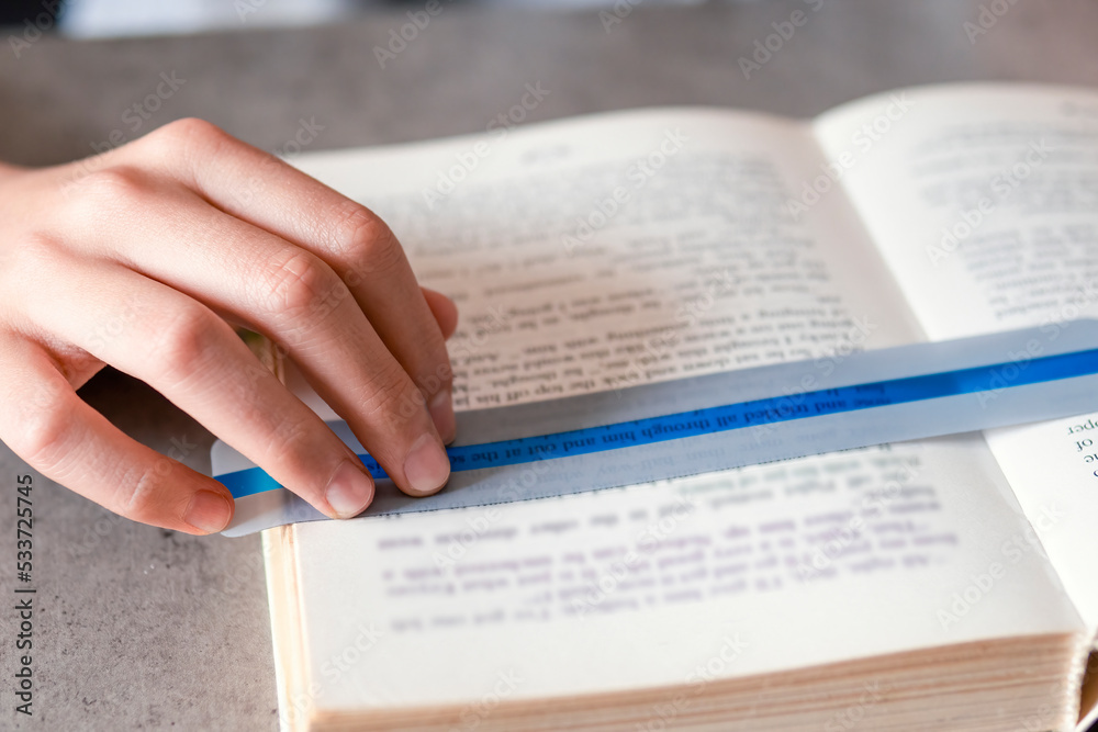 Reading tools for dyslexia. Child reading book using colorful ruler ...