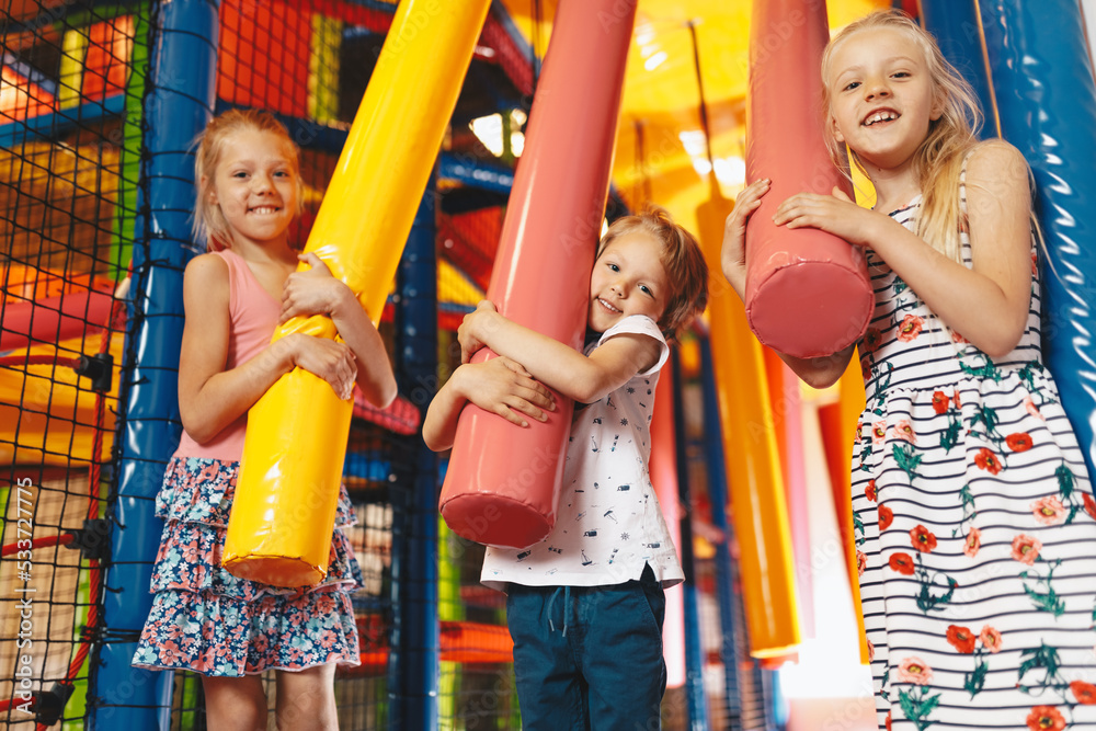 Foto de Excited kids playing together at play centre. Happy siblings ...