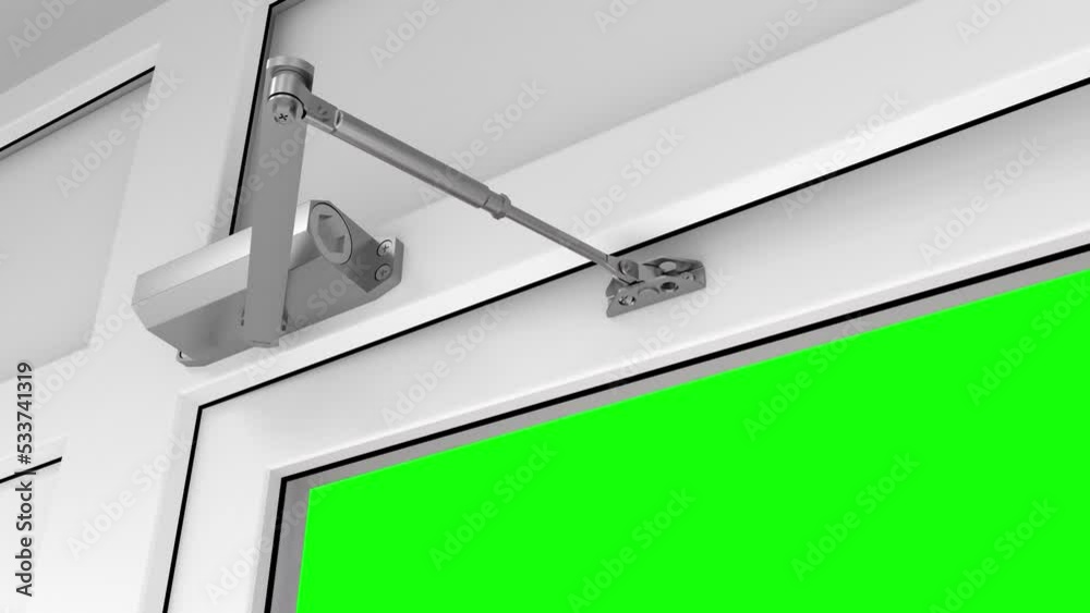 A metal door closer is mounted on top of a white plastic door against a ...