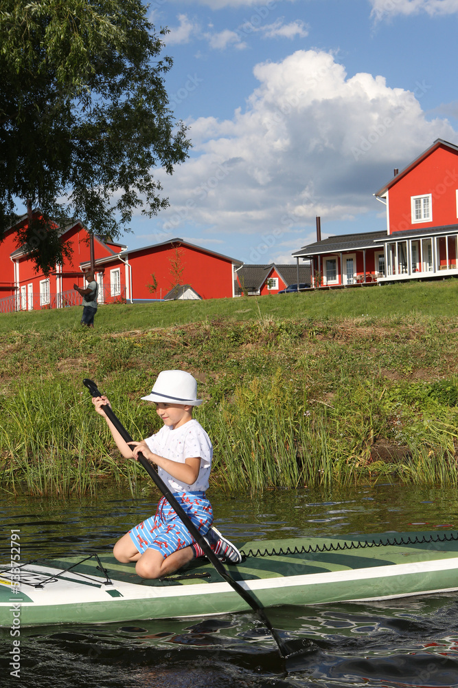 Happy russian tourist child, kid and water sport, active rest ...