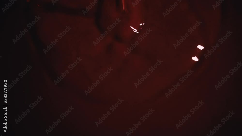 Drops of red blood drip into a puddle of blood close-up. Bloody mess ...