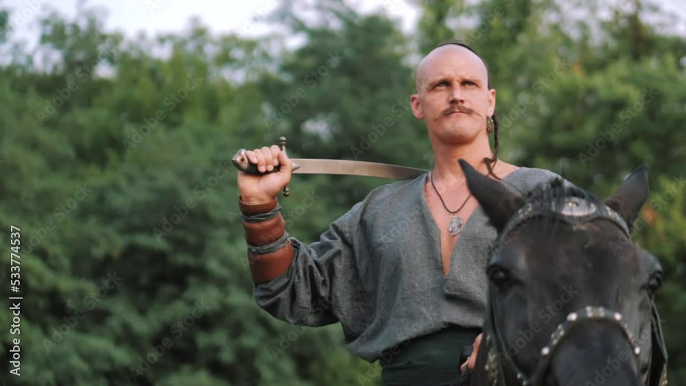 Cossack Rider on a horse. Zaporizhian Cossack with a saber on horseback ...