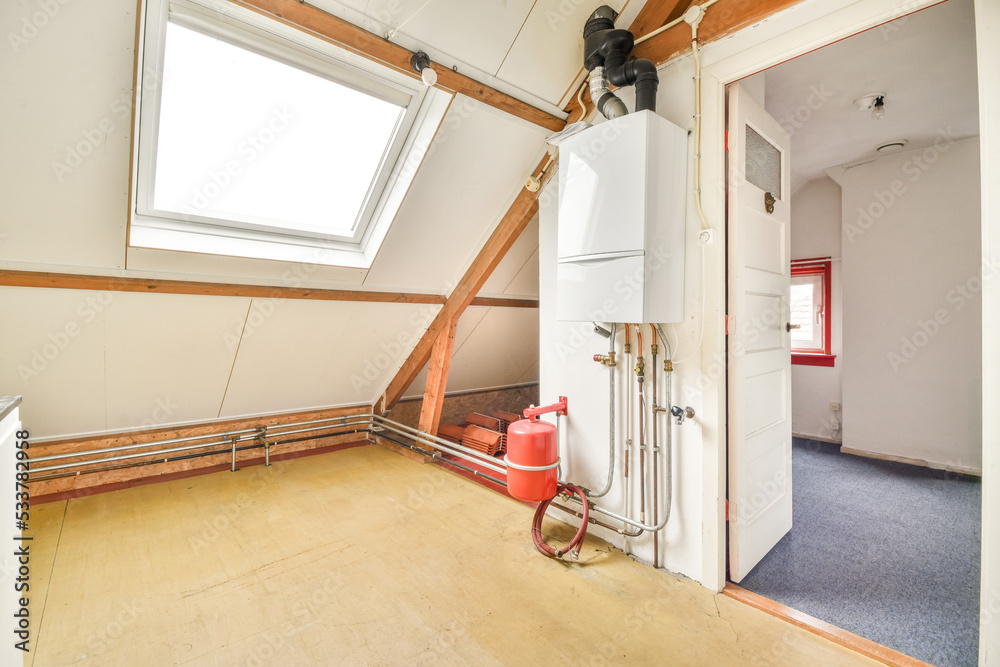 Fotka „Boiler room of an apartment building with pipes and metering ...