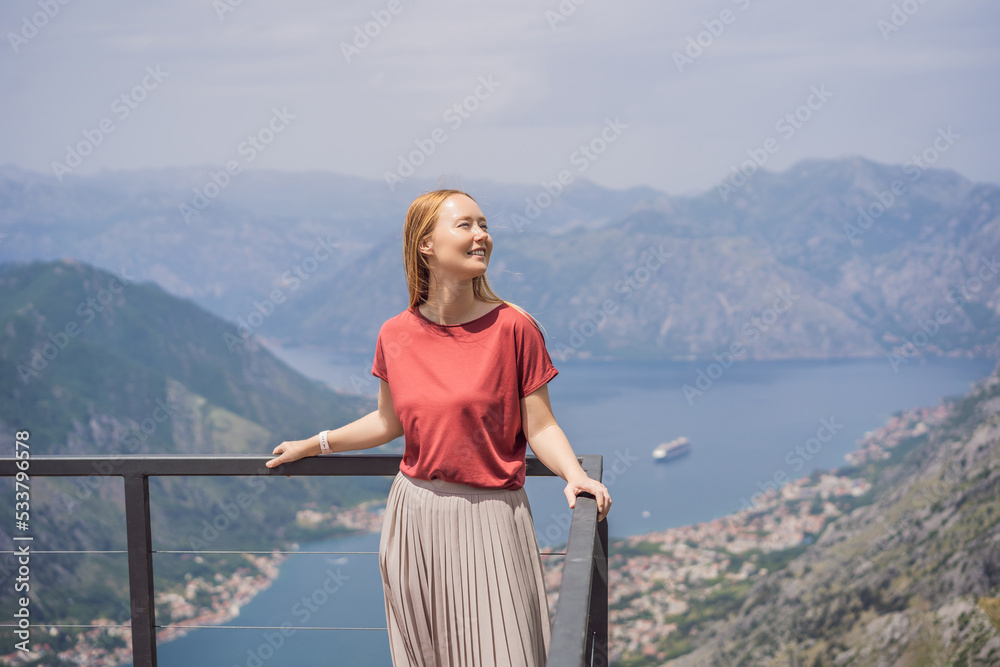 Woman tourist enjoys the view of Kotor. Montenegro. Bay of Kotor, Gulf ...