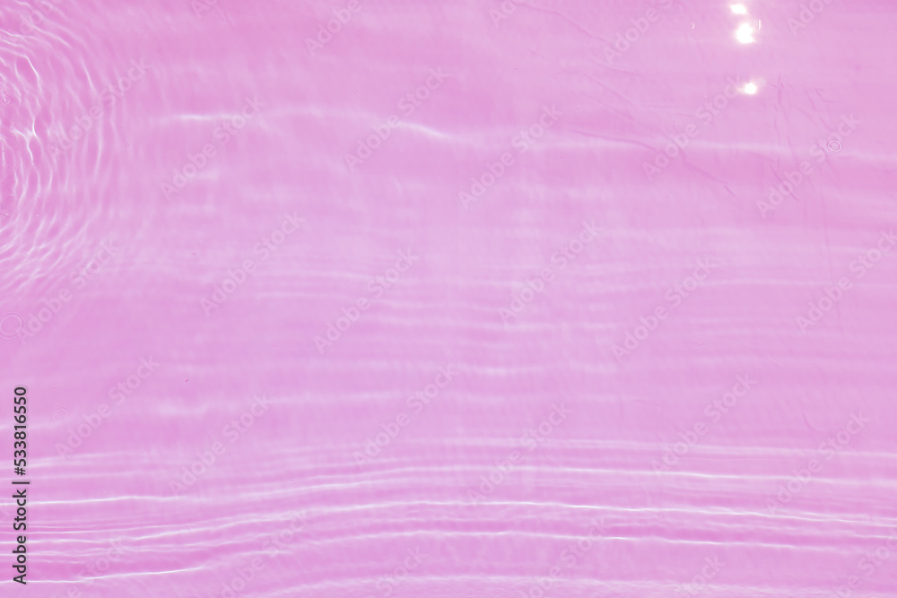 Defocus blurred transparent pink colored clear calm water surface ...