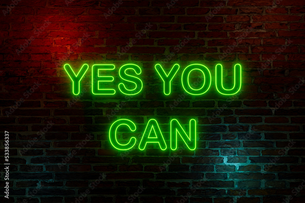 Yes you can, neon sign. Brick wall at night with the text "Yes you can ...